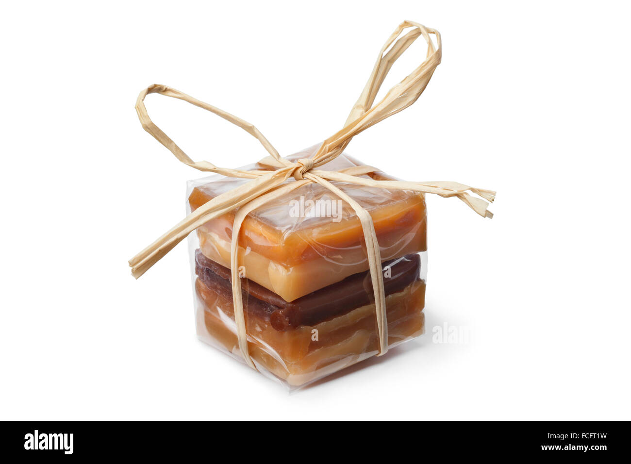 Package with a variation of sweet caramel bonbons on white background ...