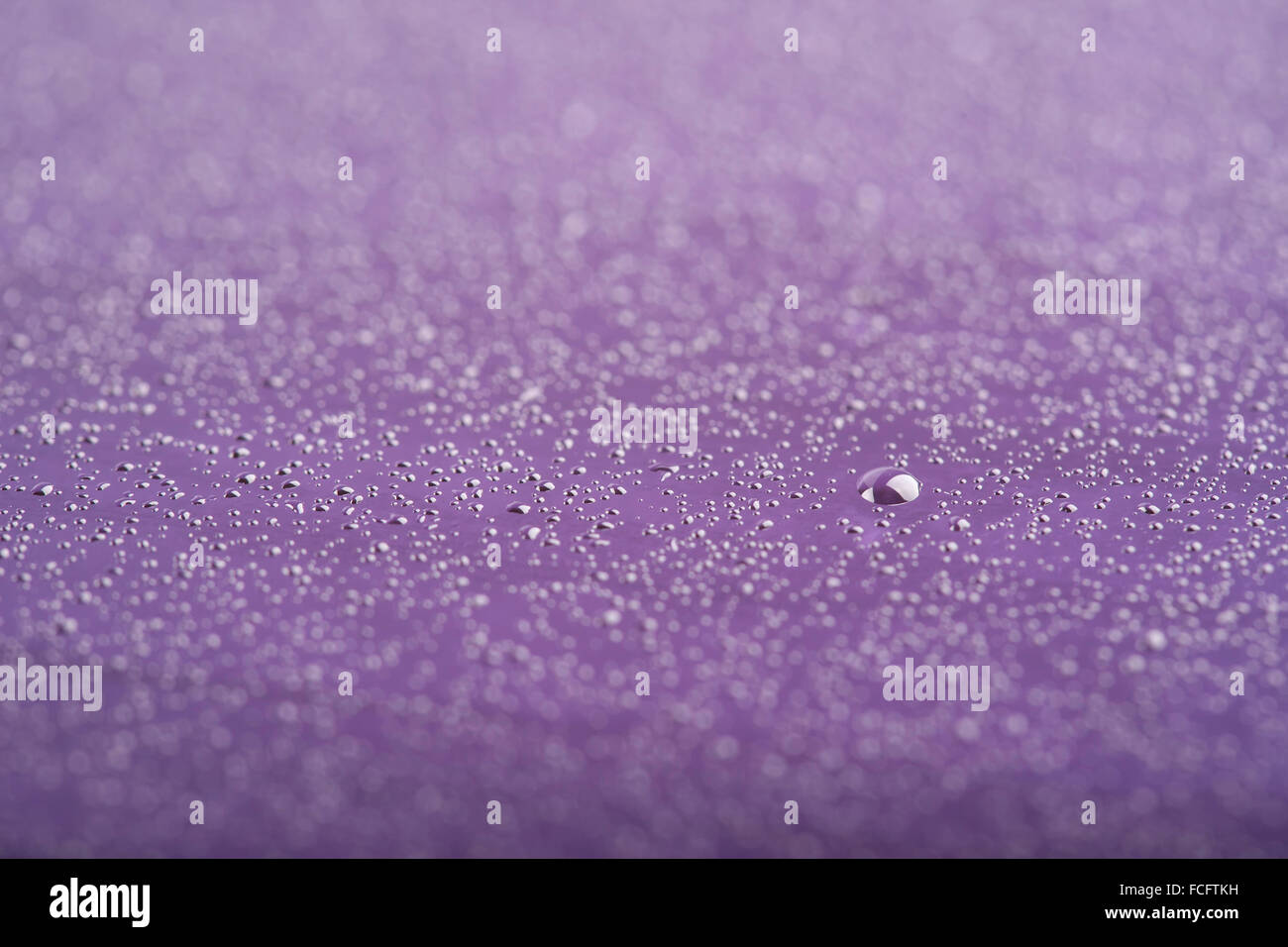 purple drops on glass closeup abstract background Stock Photo - Alamy