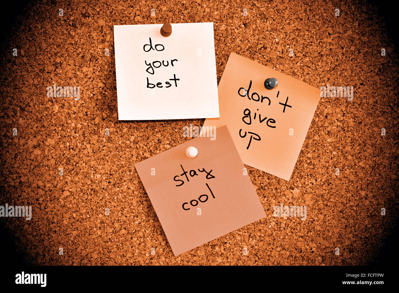 Cork notice board with three colorful sticky note pads Stock Photo - Alamy