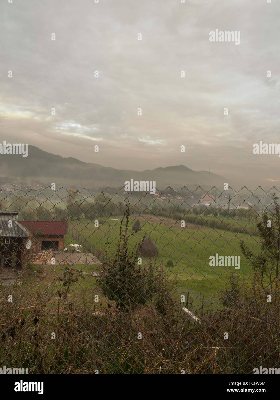 Landscape of Romanian village through fence in the Maramures region ...