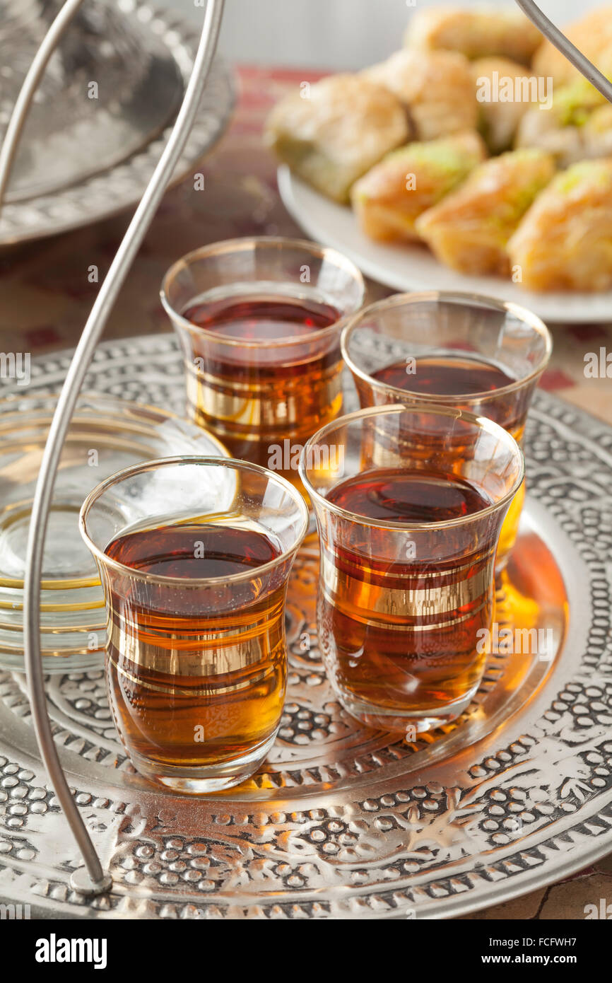 Traditional fresh Turkish tea on a tea tray and baklava Stock Photo - Alamy