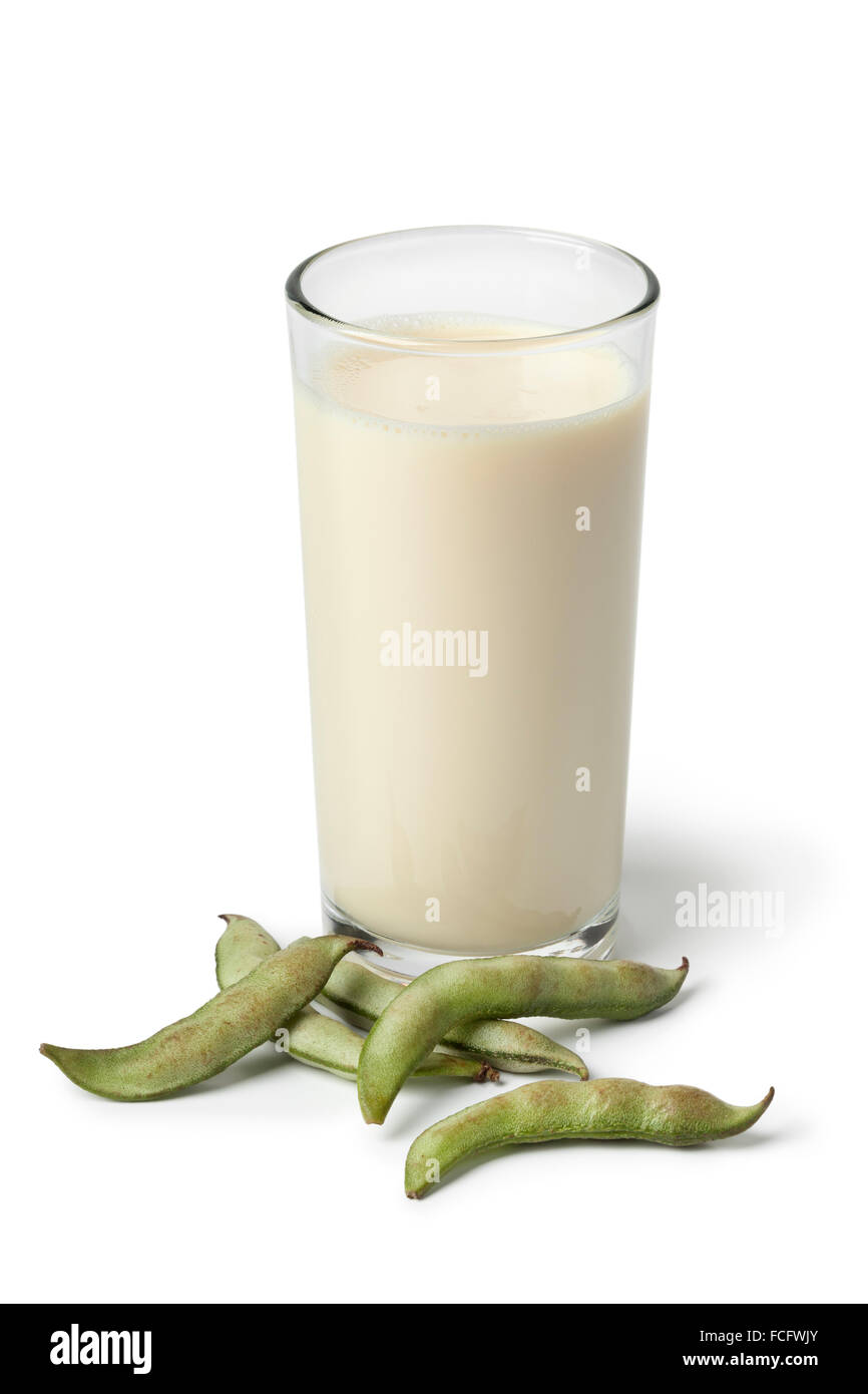 Glass of soy milk and fresh soybeans in the pod on white background ...