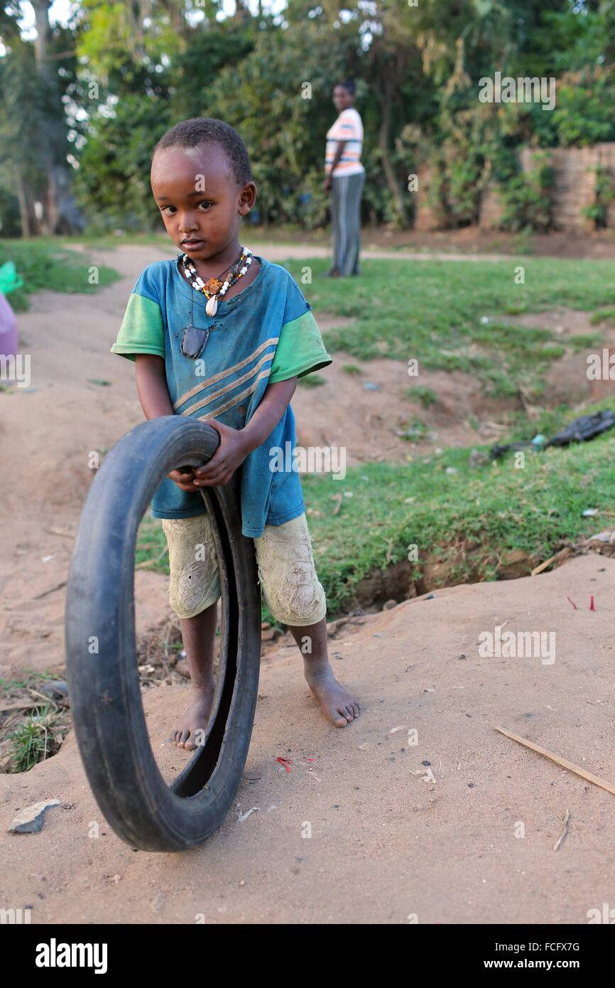 Boy playing tyre tire hi-res stock photography and images - Alamy