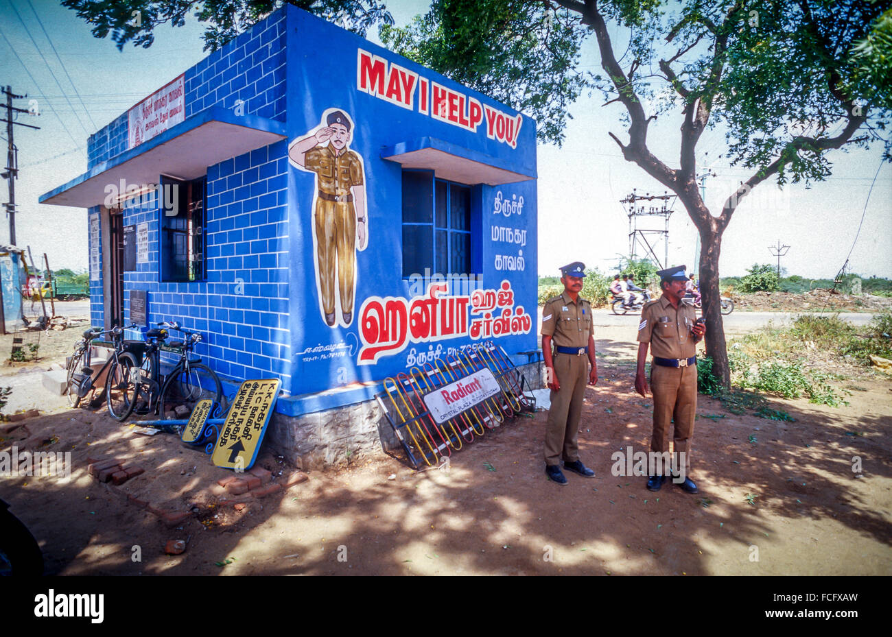 Two policeman waiting at a roadside police station in rural Tamil Nadu ...