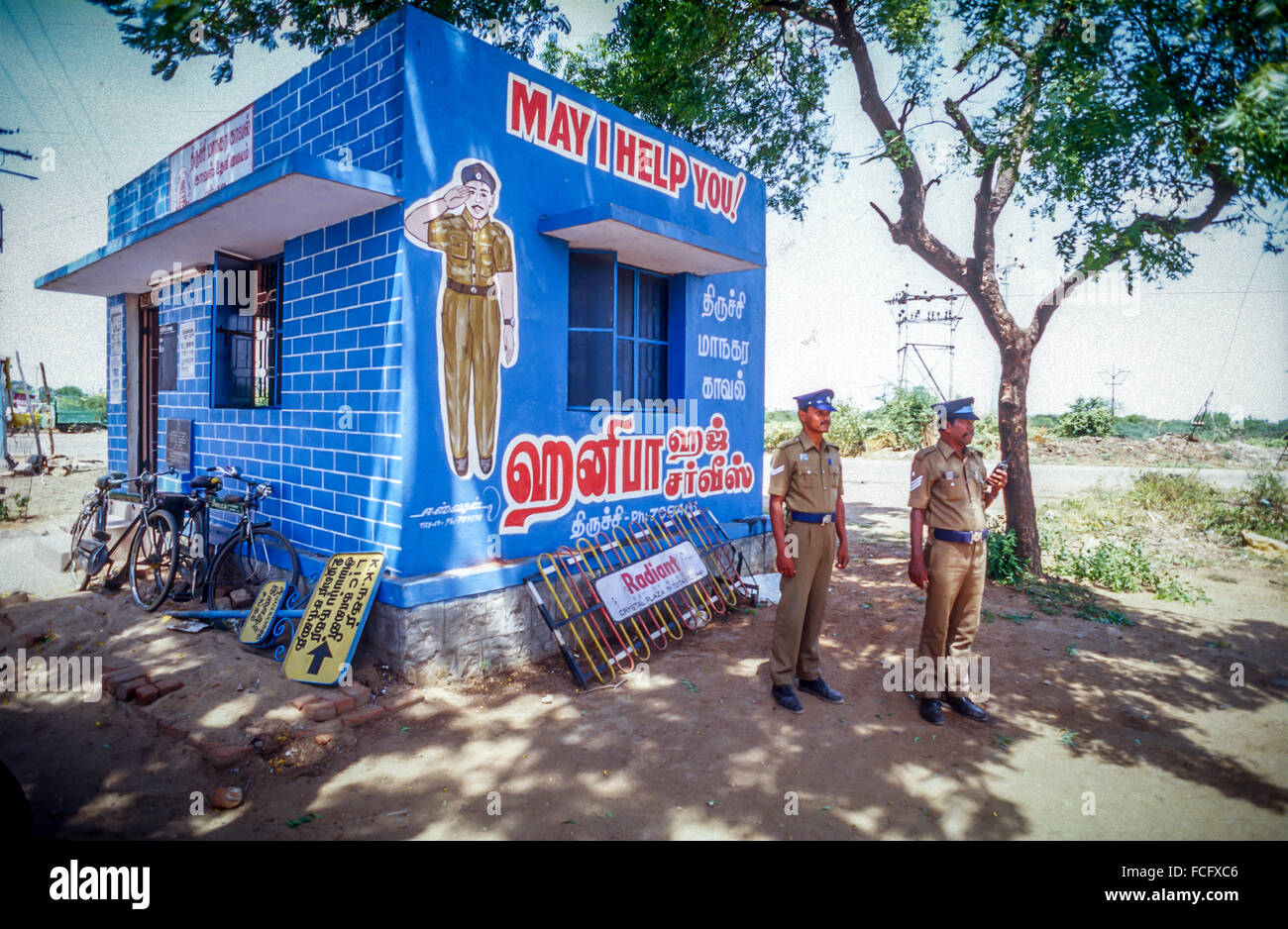 Two Policeman Waiting At A Roadside Police Station In Rural Tamil Nadu two-policeman-waiting-at-a-roadside-police-station-in-rural-tamil-nadu