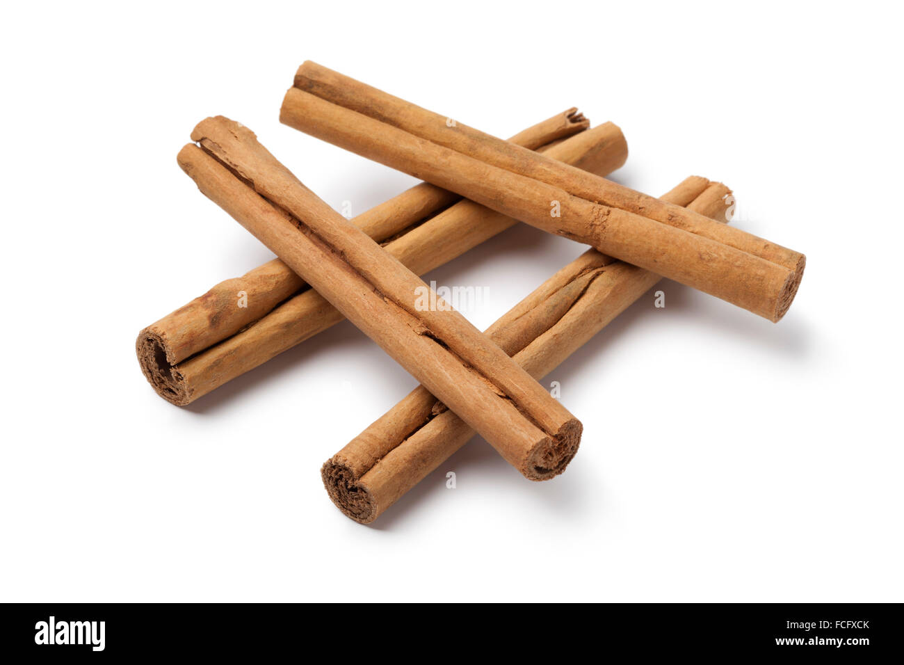 True cinnamon sticks close up on white background Stock Photo - Alamy