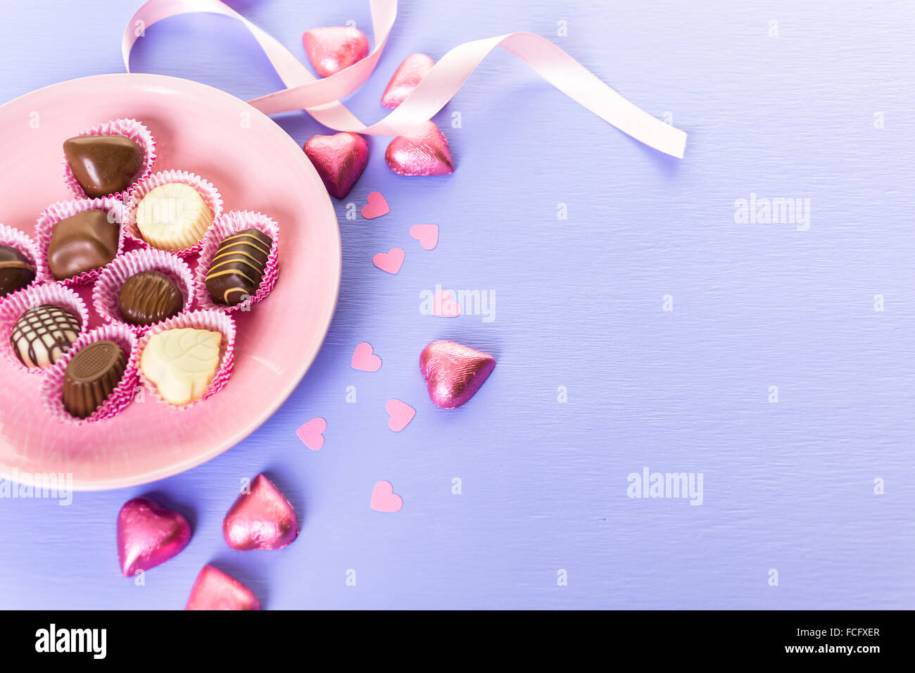 Assorted chocolates on pink plate Stock Photo - Alamy