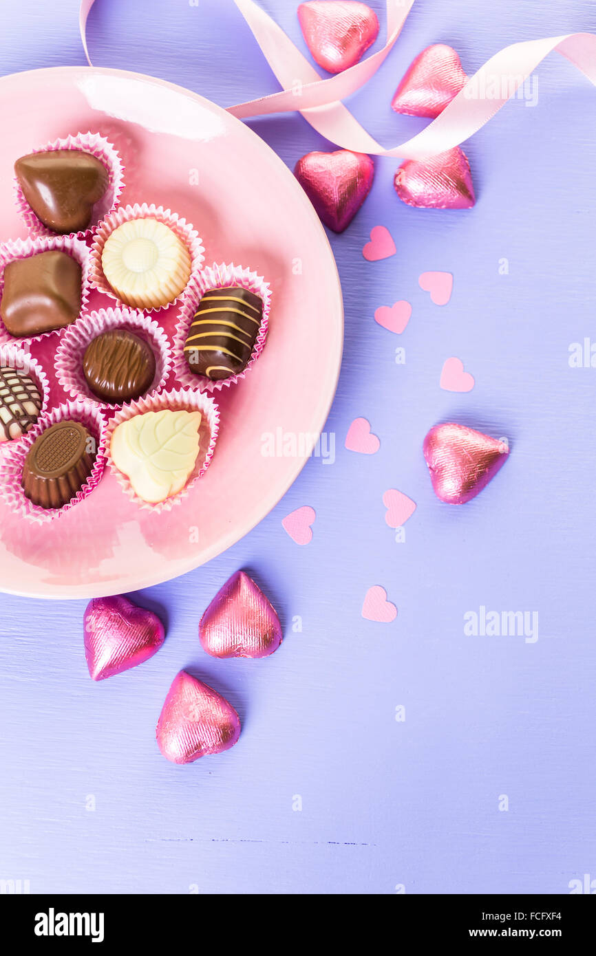 Assorted chocolates on pink plate Stock Photo - Alamy