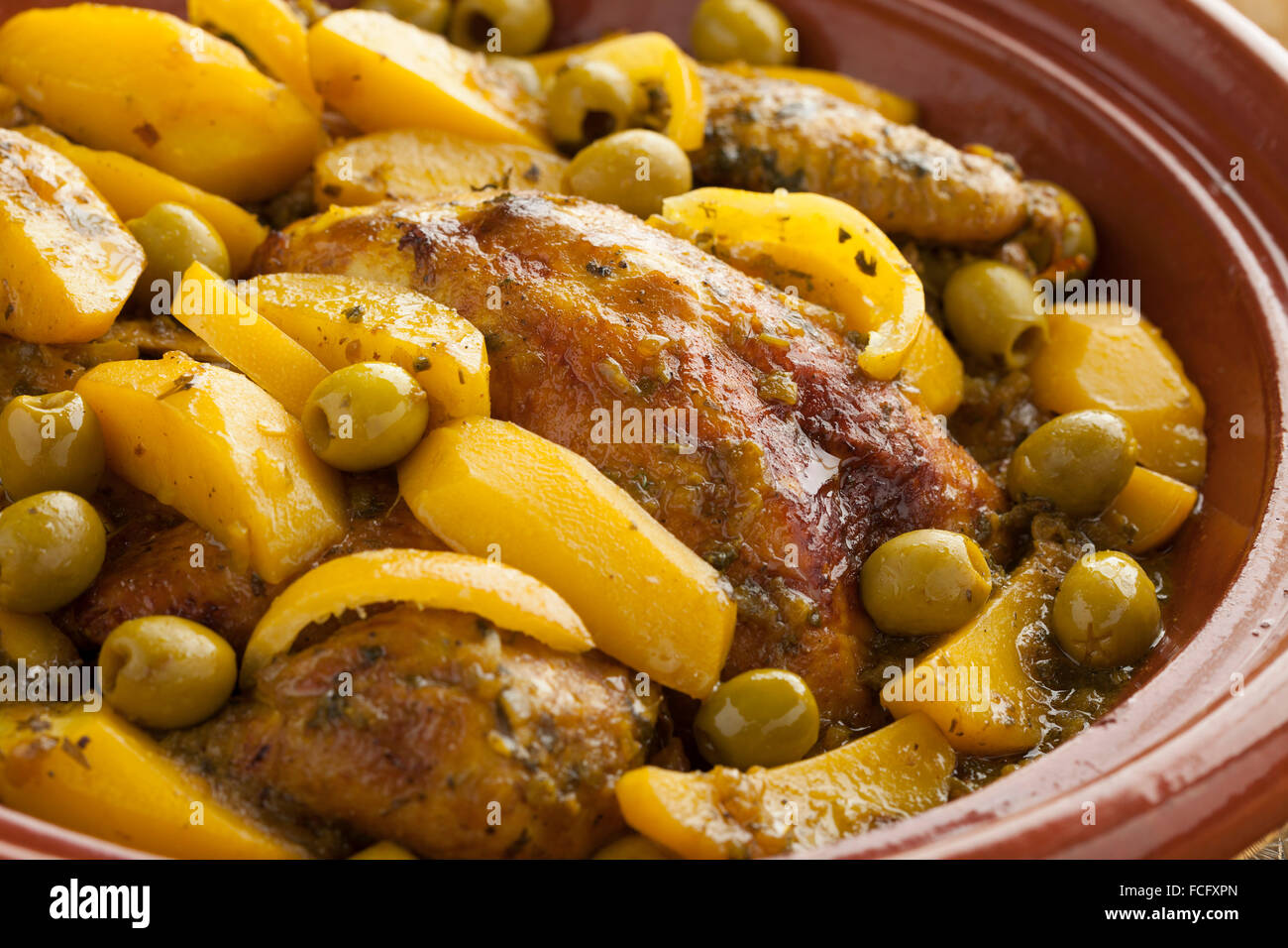Traditional moroccan tajine with chicken,pototoes and olives close up ...