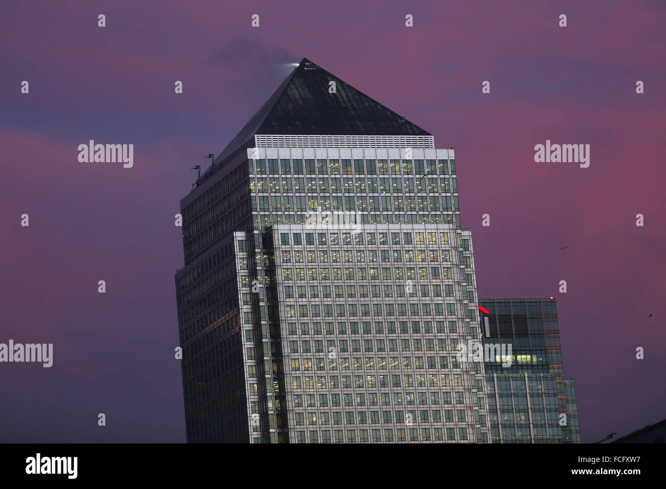 One Canada Square Canary Wharf in London UK at sunset shining through ...