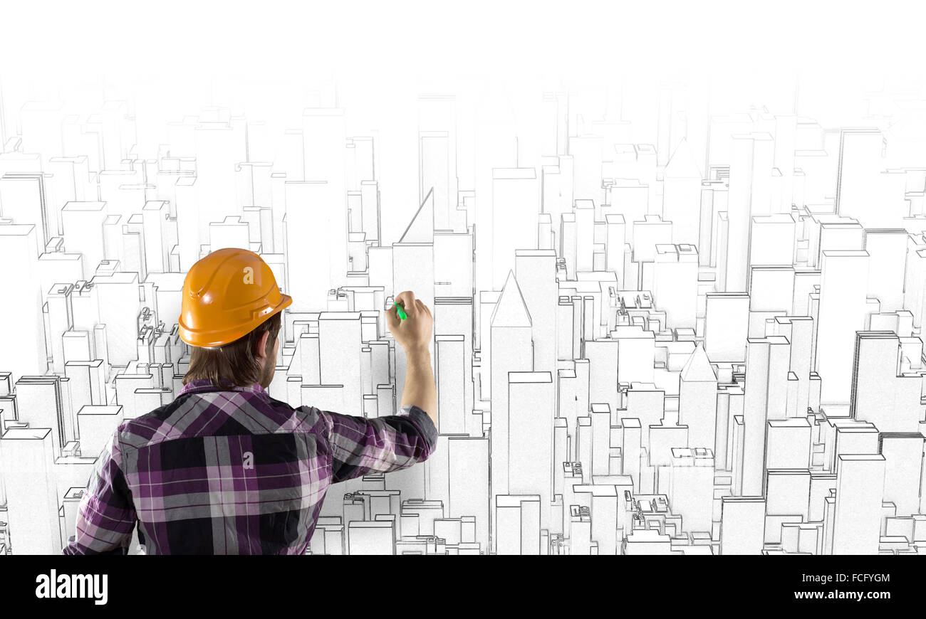Rear view of engineer drawing project of business district Stock Photo ...