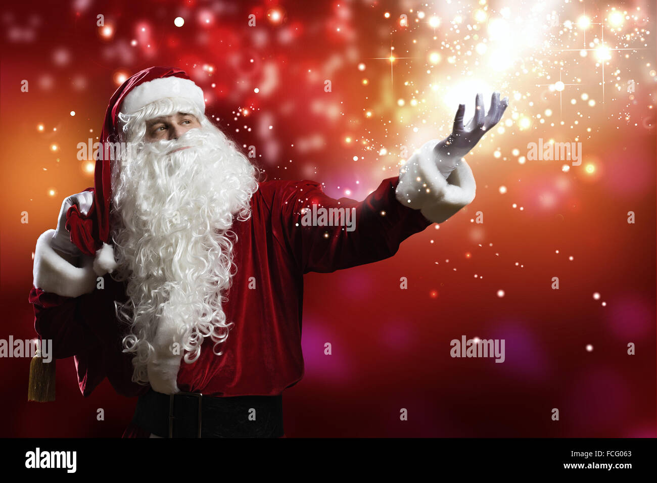 Santa Clause with gift bag behind shoulders Stock Photo - Alamy
