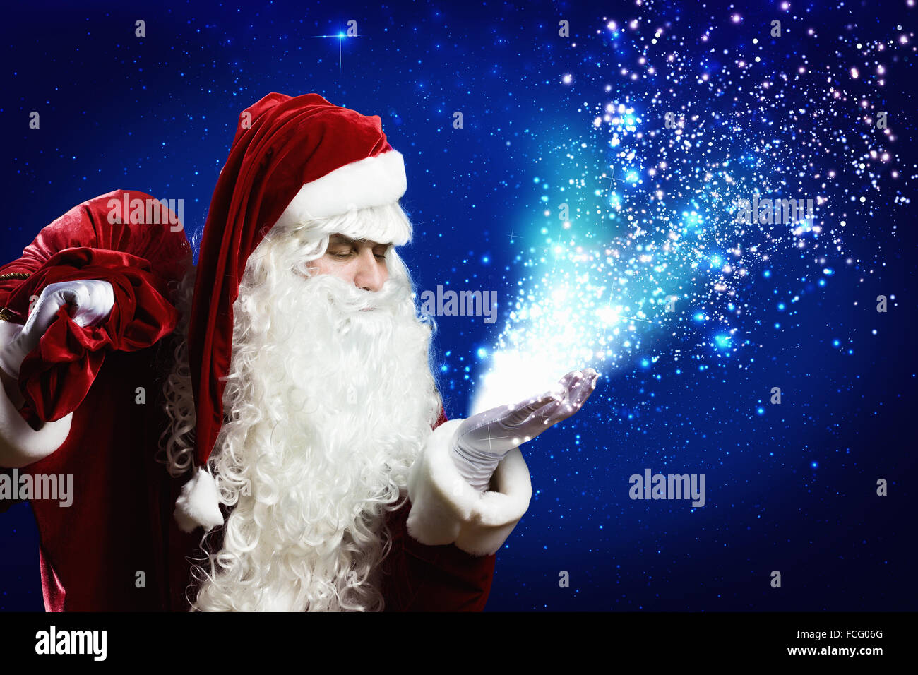 Santa Clause with gift bag behind shoulders Stock Photo - Alamy