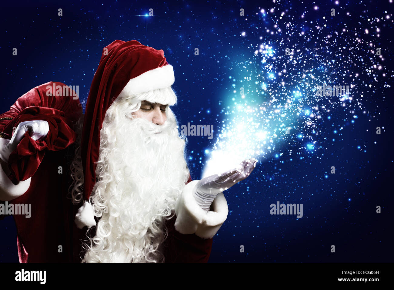 Santa Clause with gift bag behind shoulders Stock Photo - Alamy