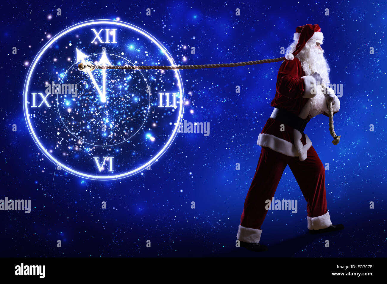 Santa Claus pulling arrow of clock with rope Stock Photo - Alamy