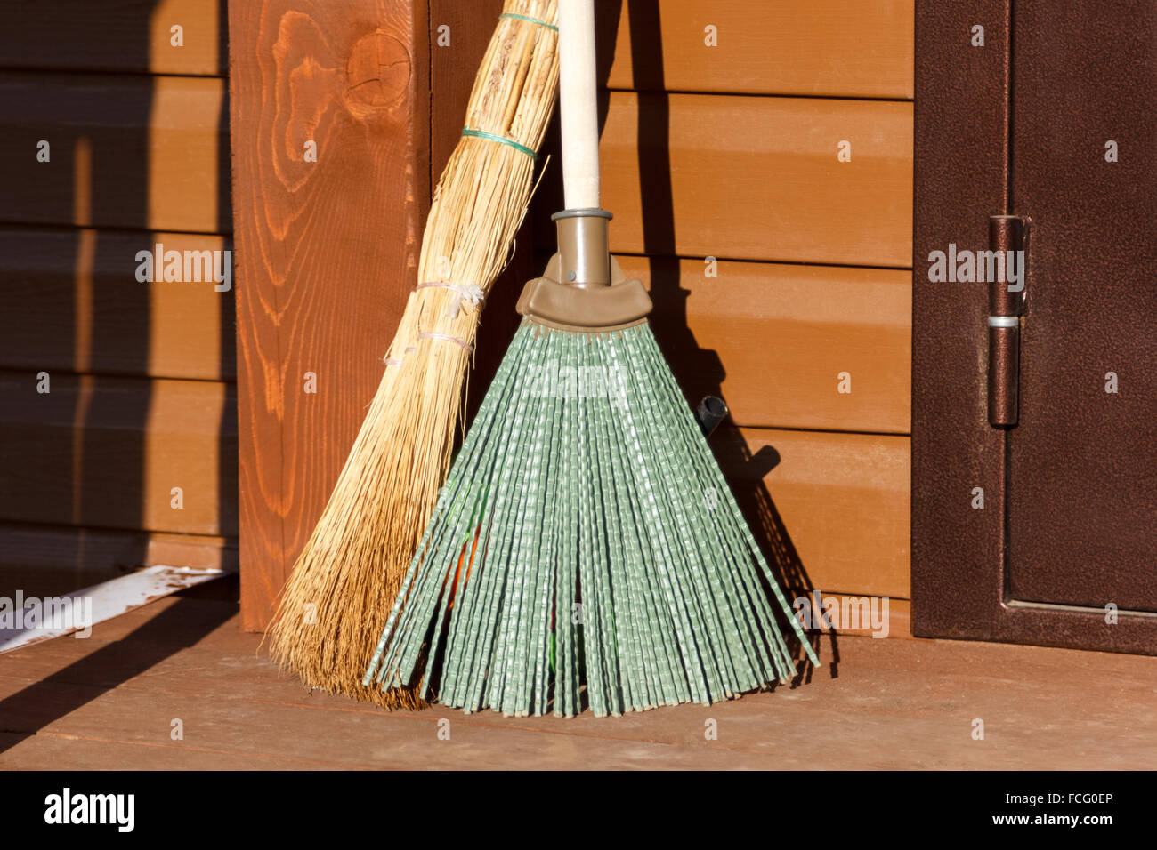 broom and besom standing on the wooden floor Stock Photo - Alamy