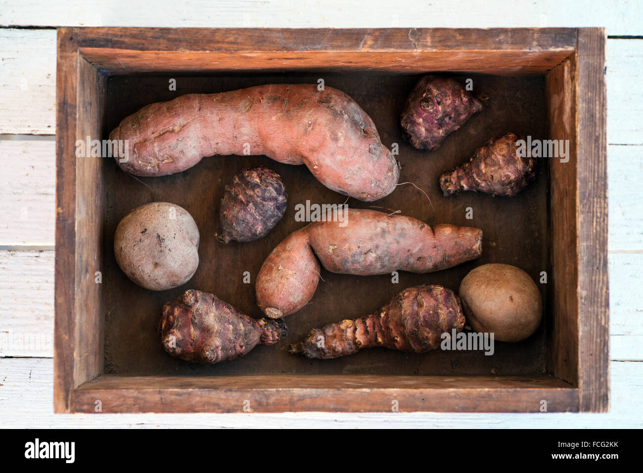 Sweet potato, jerusalem artichoke and potato in wooden box Stock Photo ...