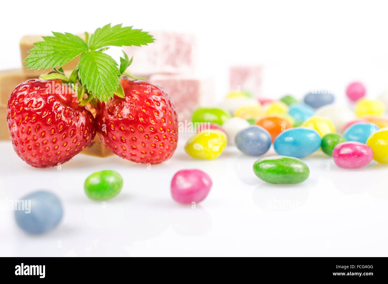Red strawberries, and multicolored dragees Stock Photo - Alamy