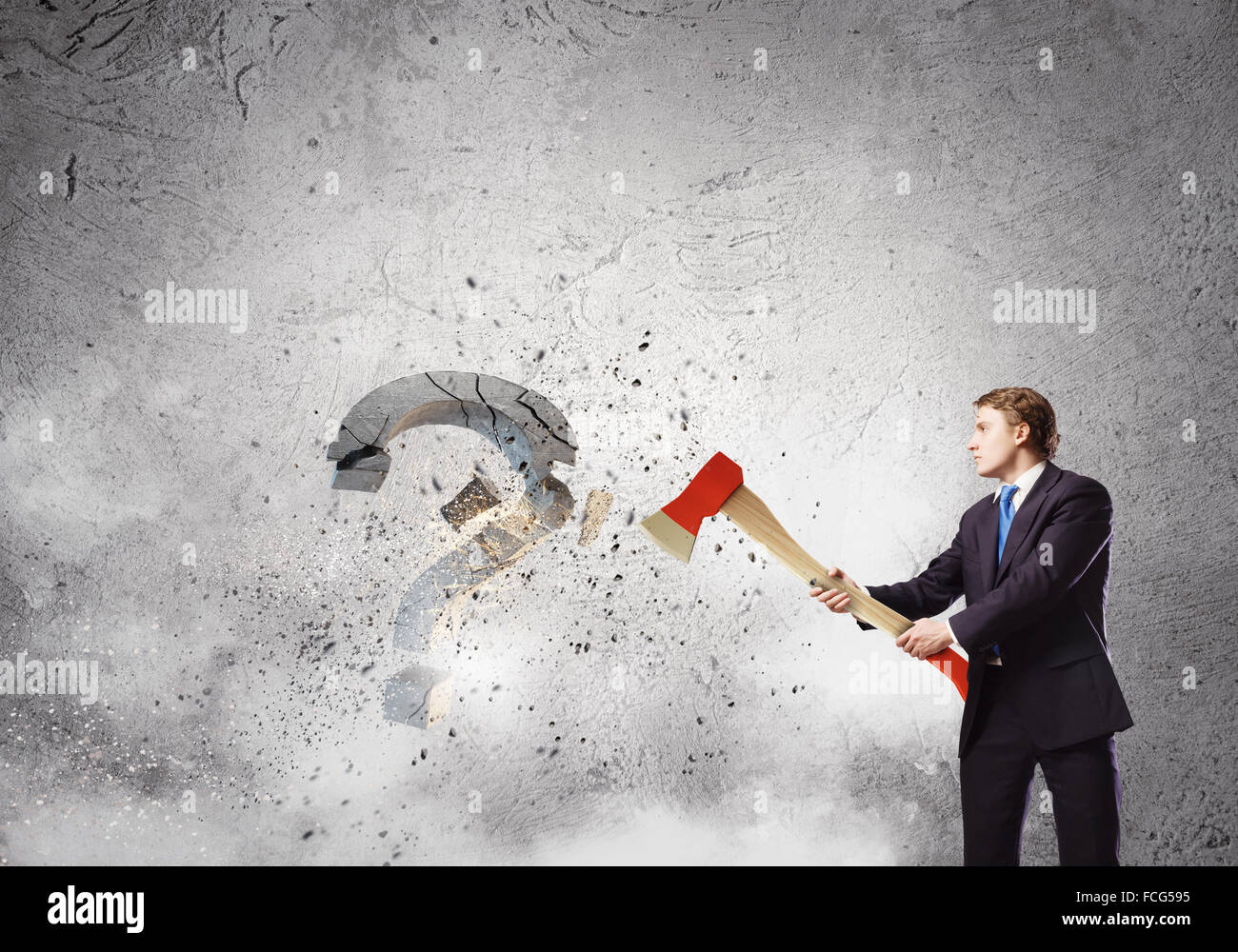 Businessman breaking stone question mark with axe Stock Photo - Alamy