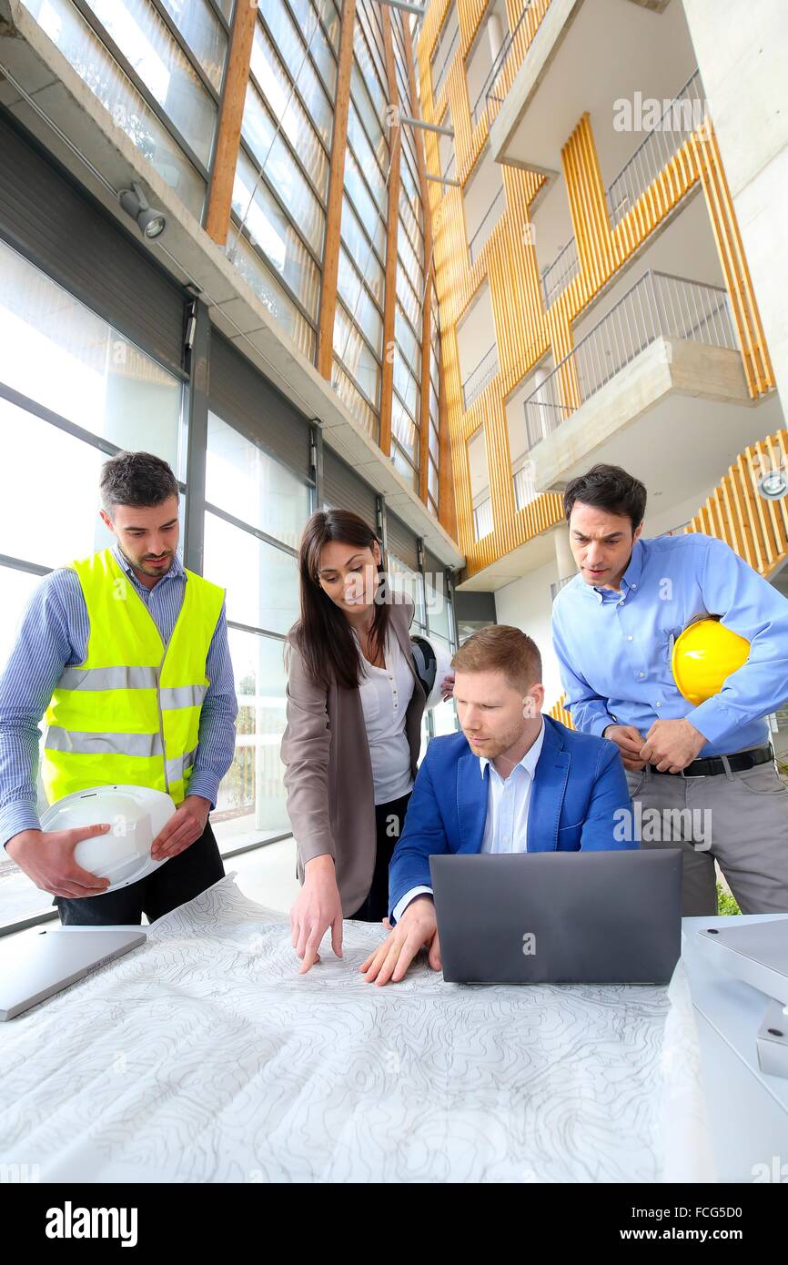 Engineers looking at map Stock Photo - Alamy