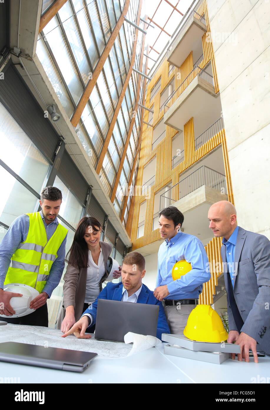 Engineers looking at map Stock Photo - Alamy