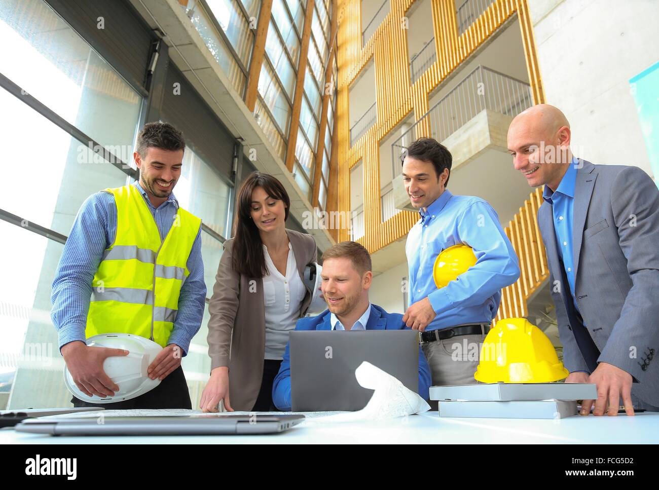 Engineers looking at map Stock Photo - Alamy
