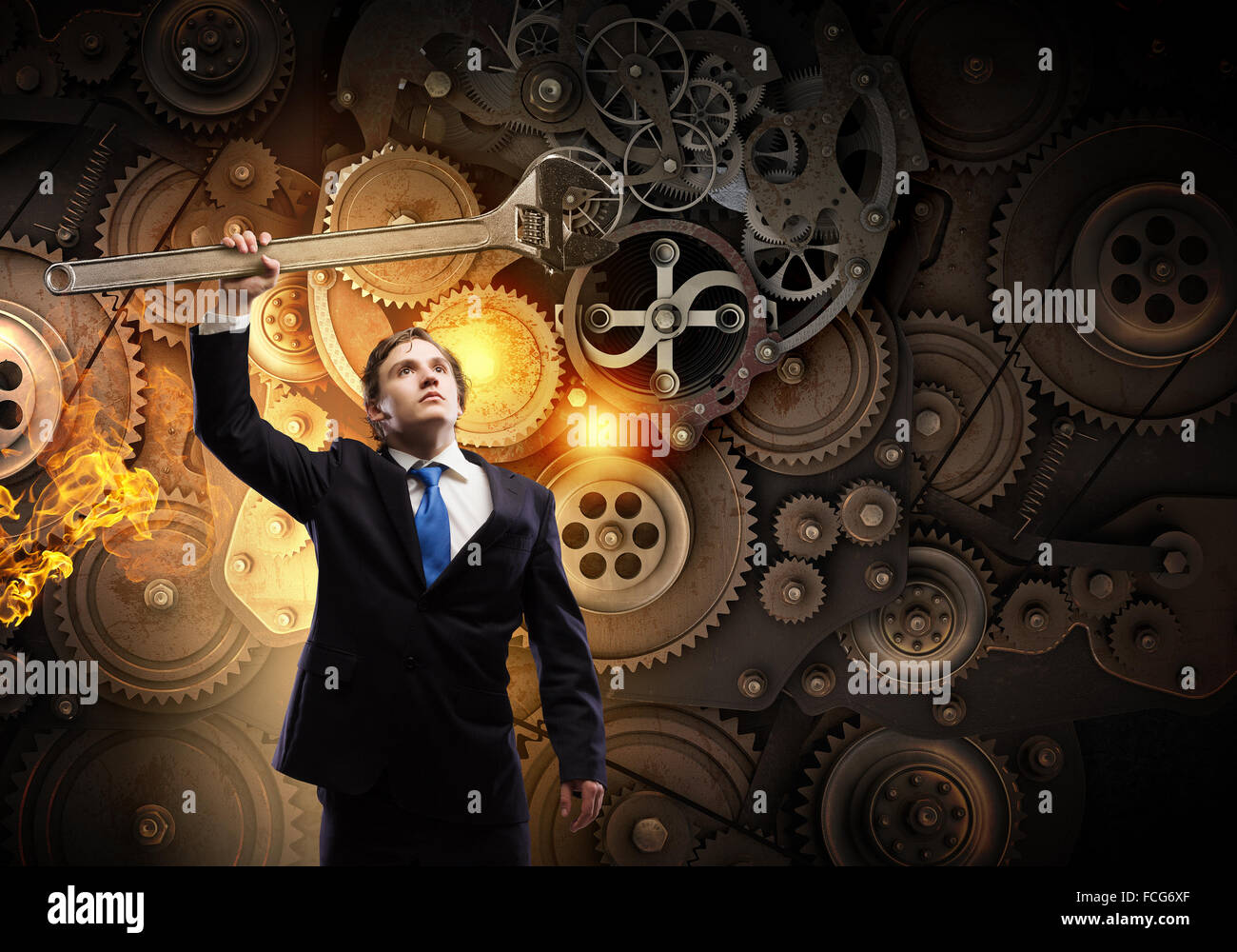 Young businessman fixing gears mechanism with wrench Stock Photo - Alamy