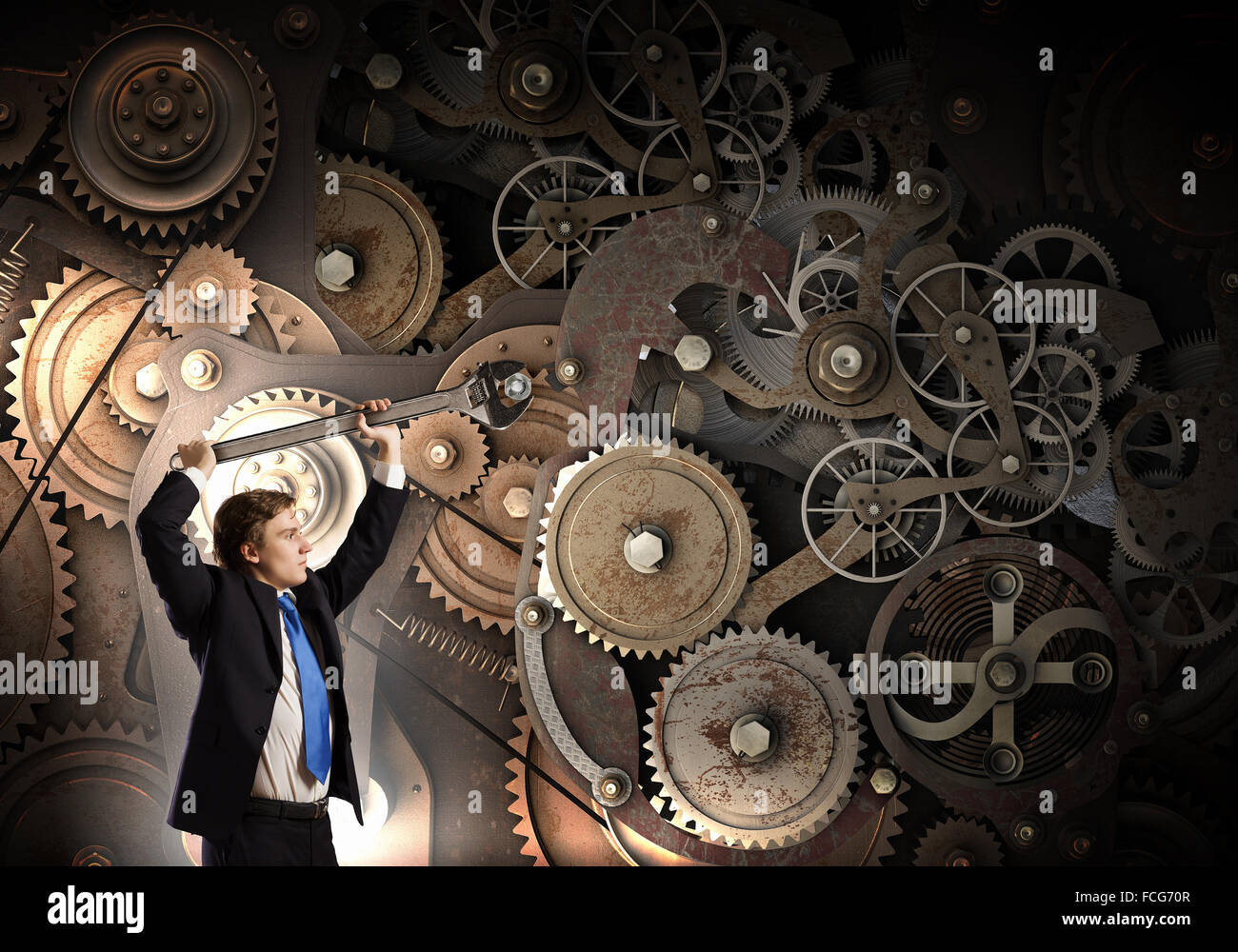 Young businessman fixing gears mechanism with wrench Stock Photo - Alamy