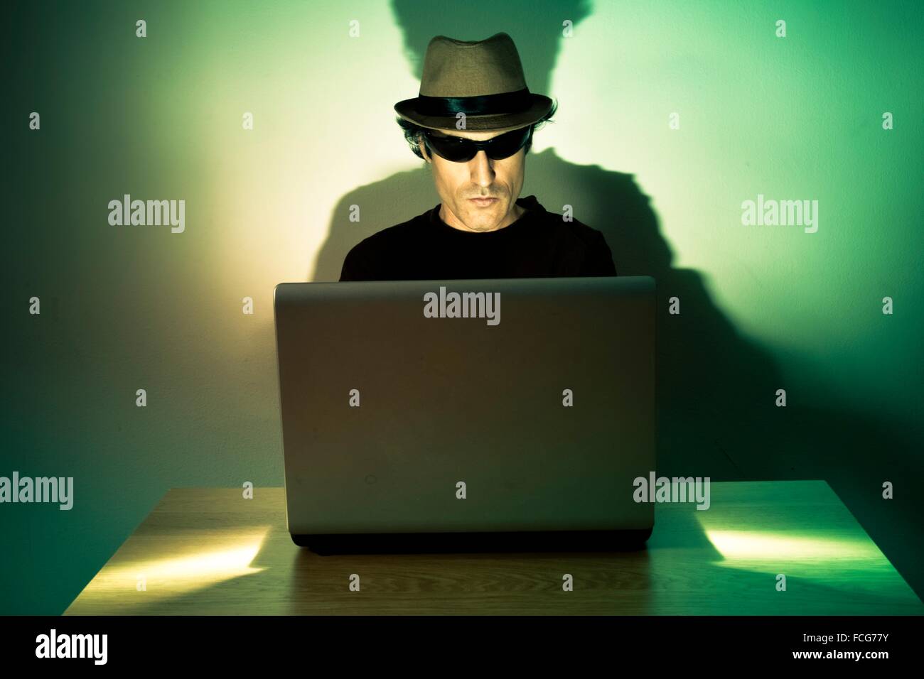 Hacker typing on a laptop Stock Photo - Alamy