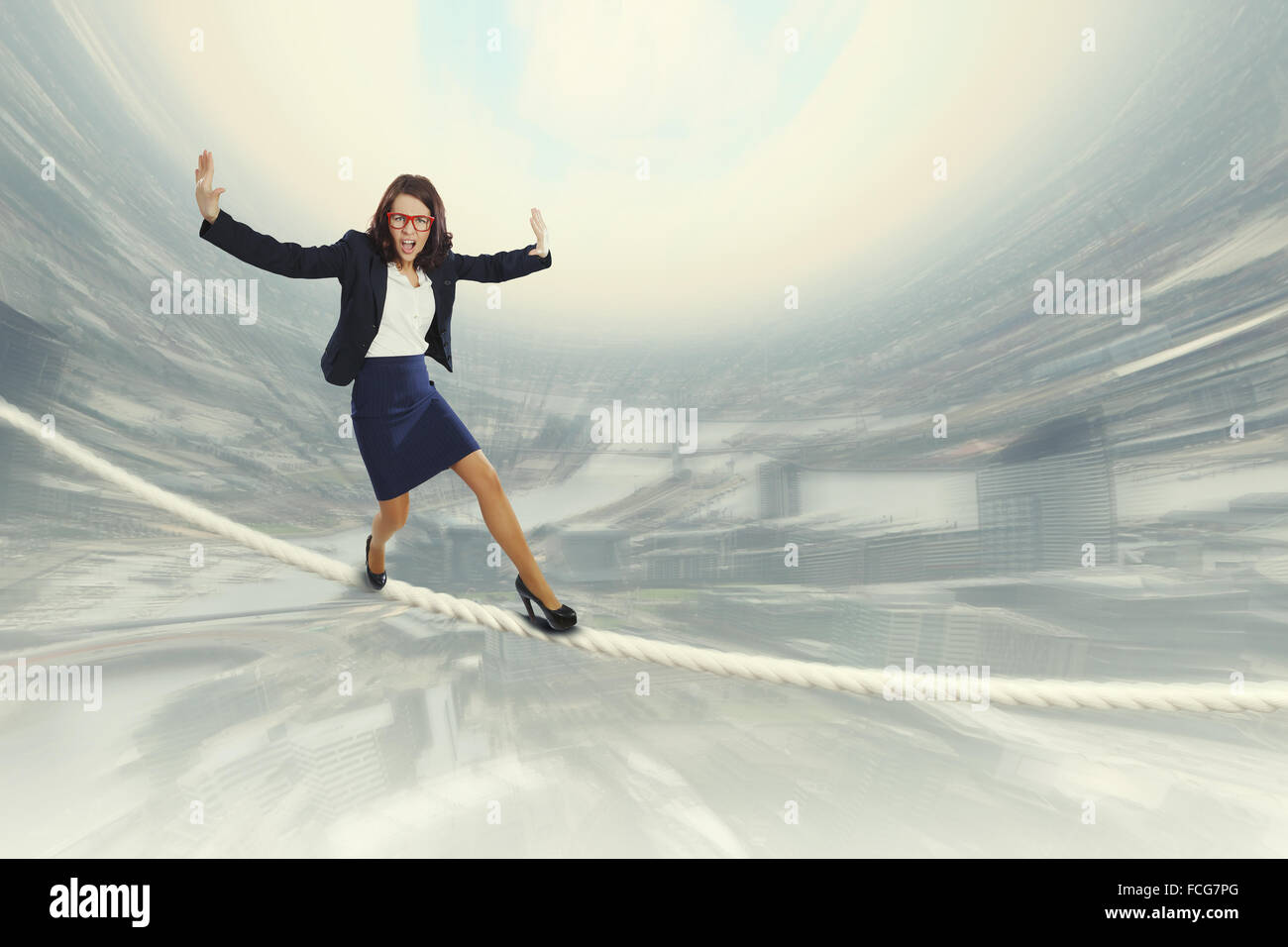 Young businesswoman balancing on rope above city Stock Photo - Alamy
