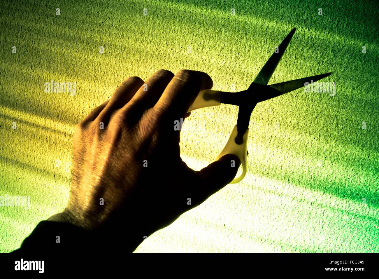 Hand holding open scissors Stock Photo - Alamy