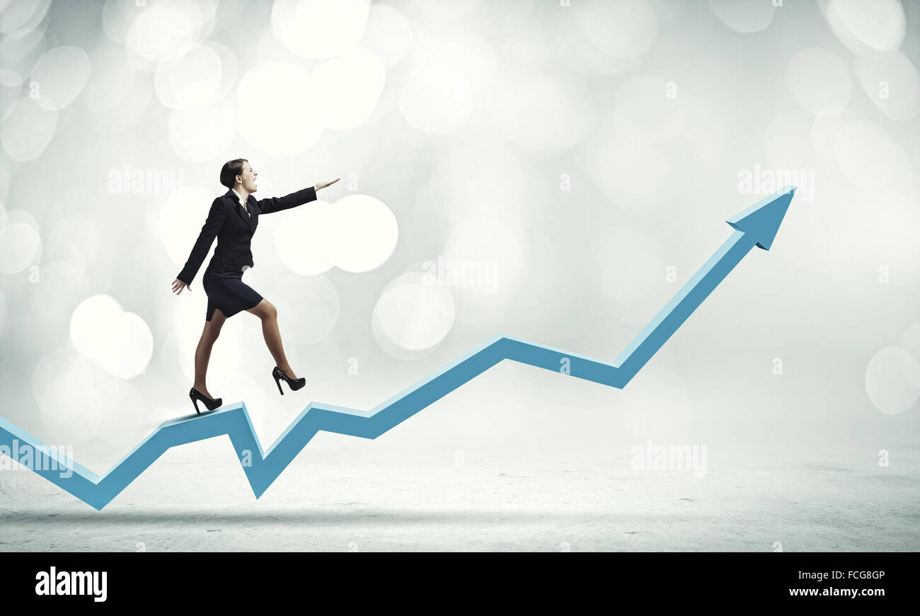 Young cheerful businesswoman walking on increasing graph Stock Photo ...