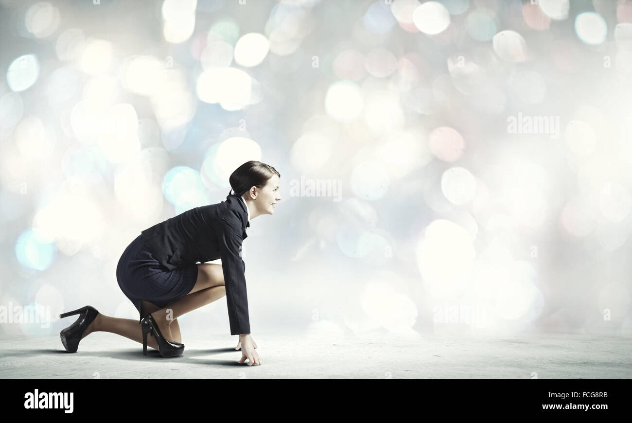 Side view of businesswoman in suit ready to run Stock Photo - Alamy