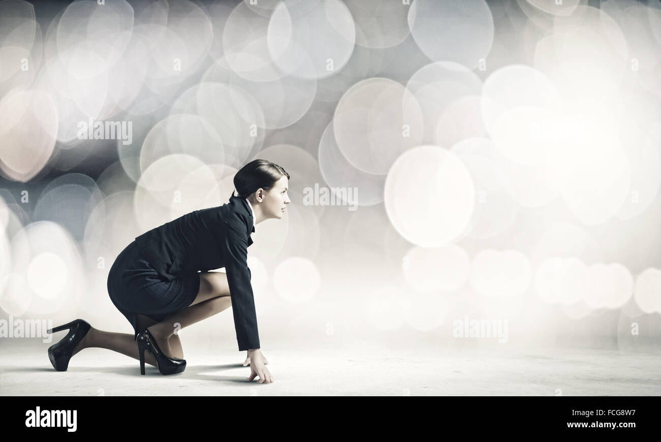 Side view of businesswoman in suit ready to run Stock Photo - Alamy