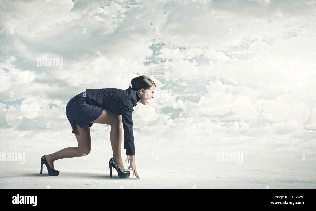Side view of businesswoman in suit ready to run Stock Photo - Alamy