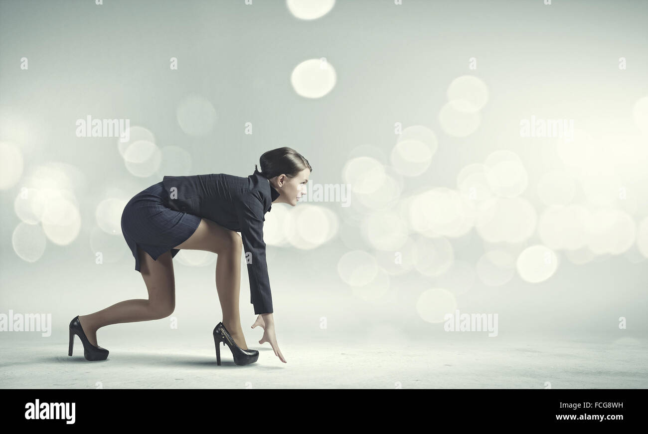 Side view of businesswoman in suit ready to run Stock Photo - Alamy