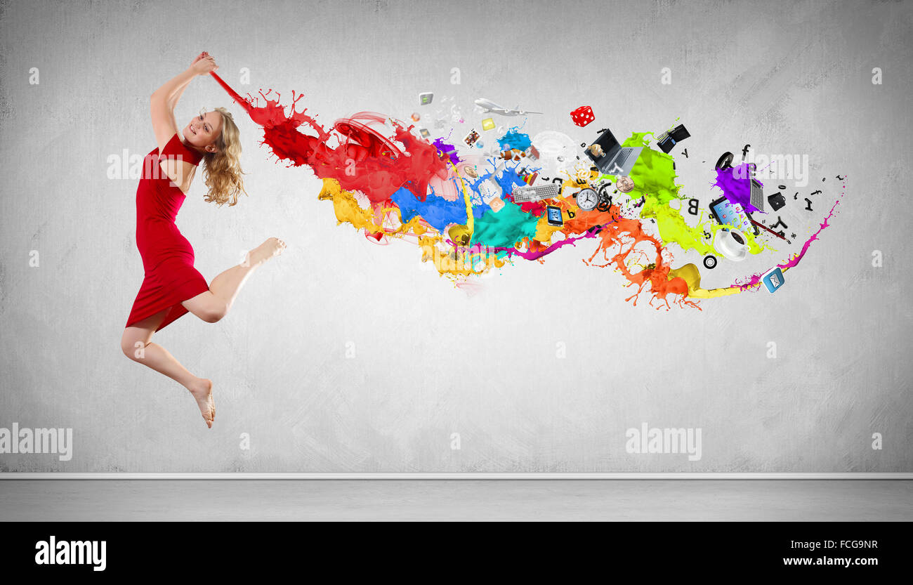 Young woman dancer in red dress jumping high Stock Photo - Alamy