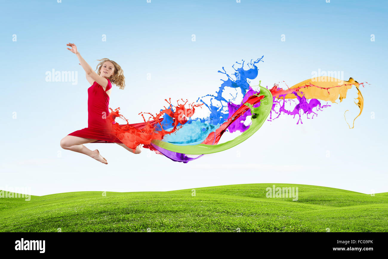 Young woman dancer in red dress jumping high Stock Photo - Alamy