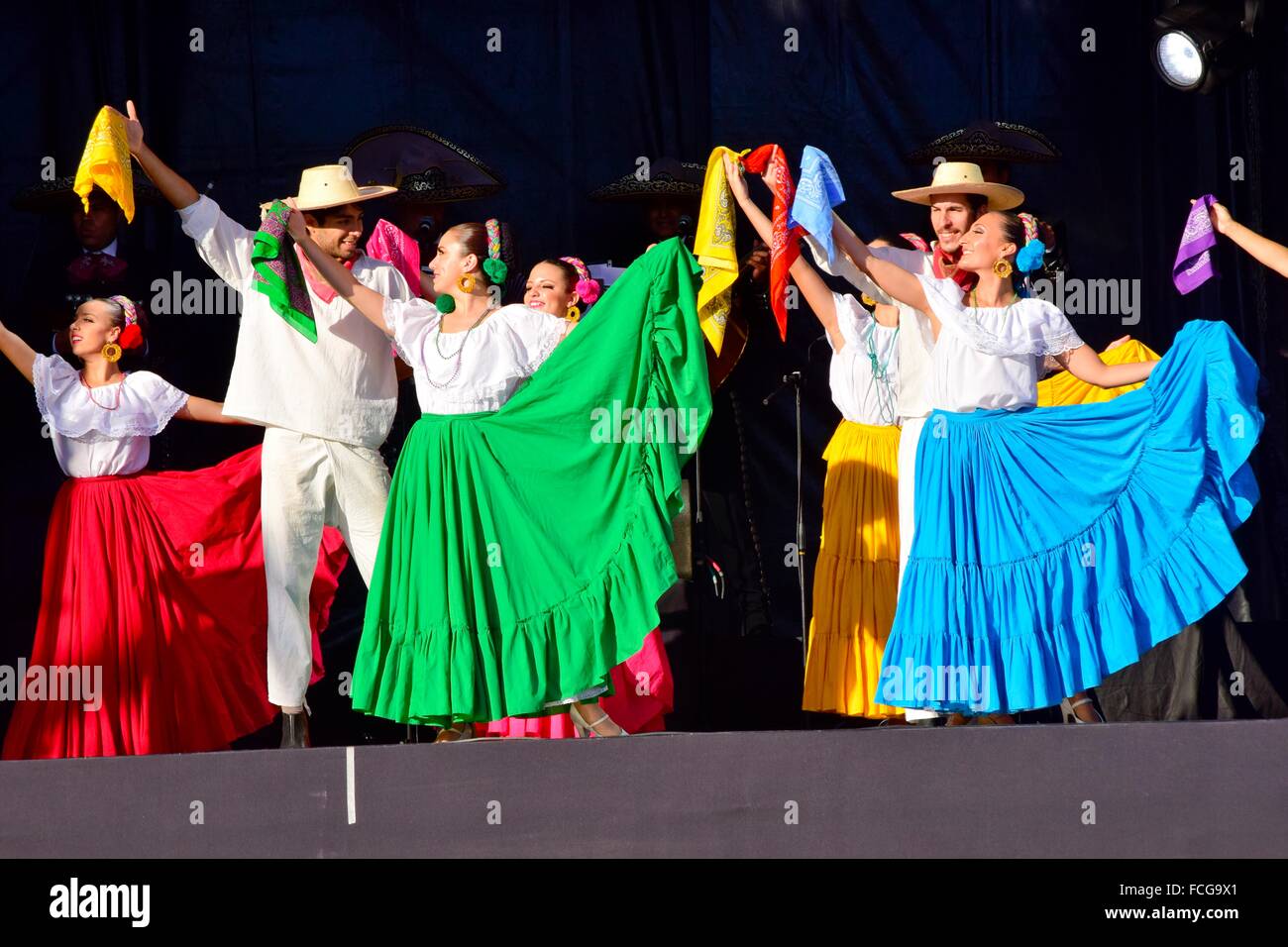 Men and women are dancing a folk dance of Mexico. The dancers wear ...