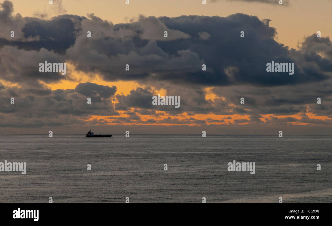 A cargo ship on the North sea at sunrise Stock Photo - Alamy