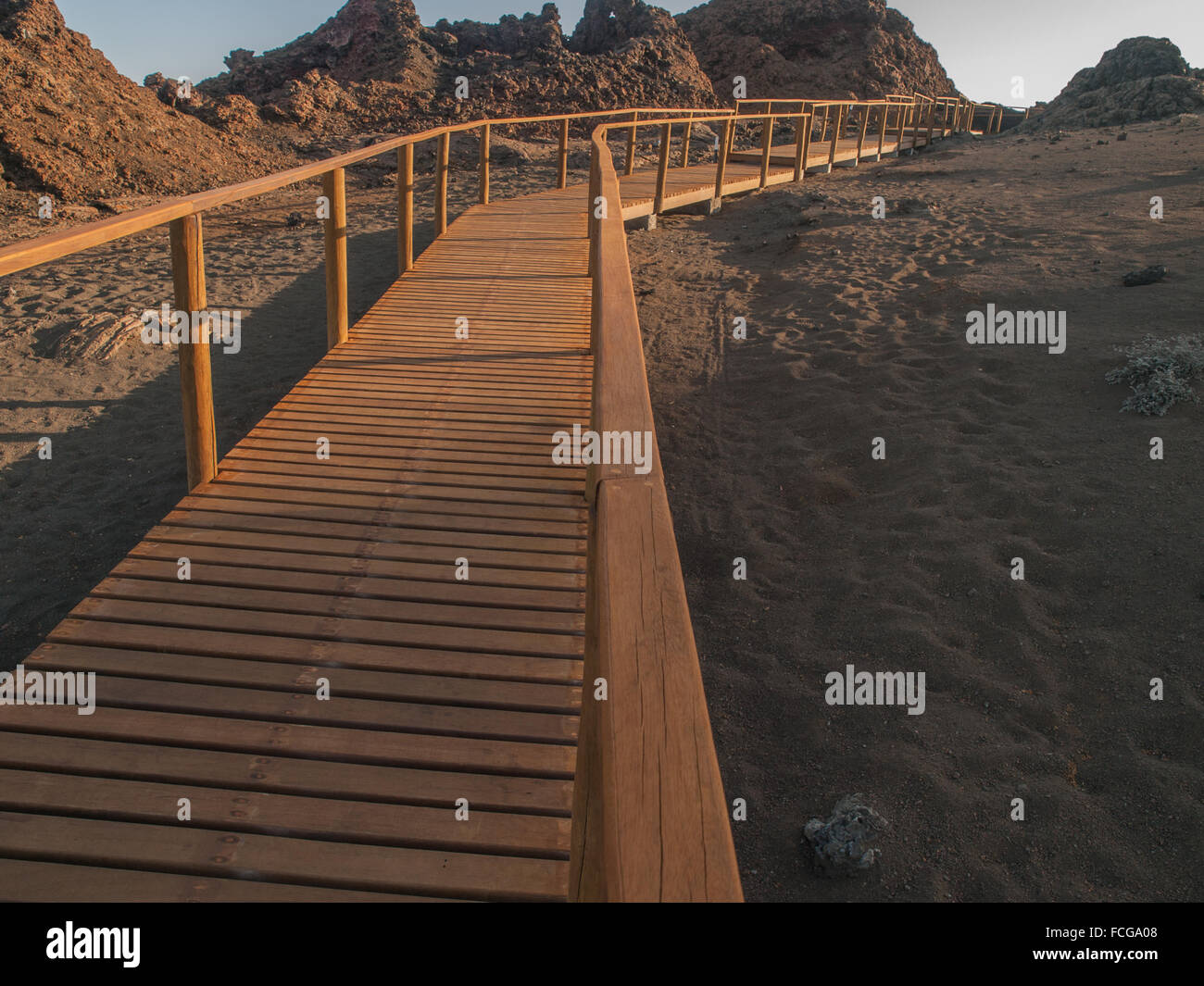Wooden plank boardwalk with railing climbing uphill to a viewing ...