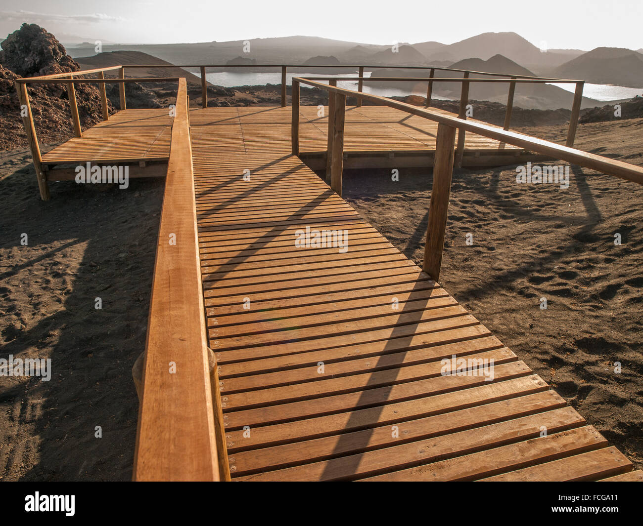 Wooden plank boardwalk with railing climbing uphill to a viewing ...