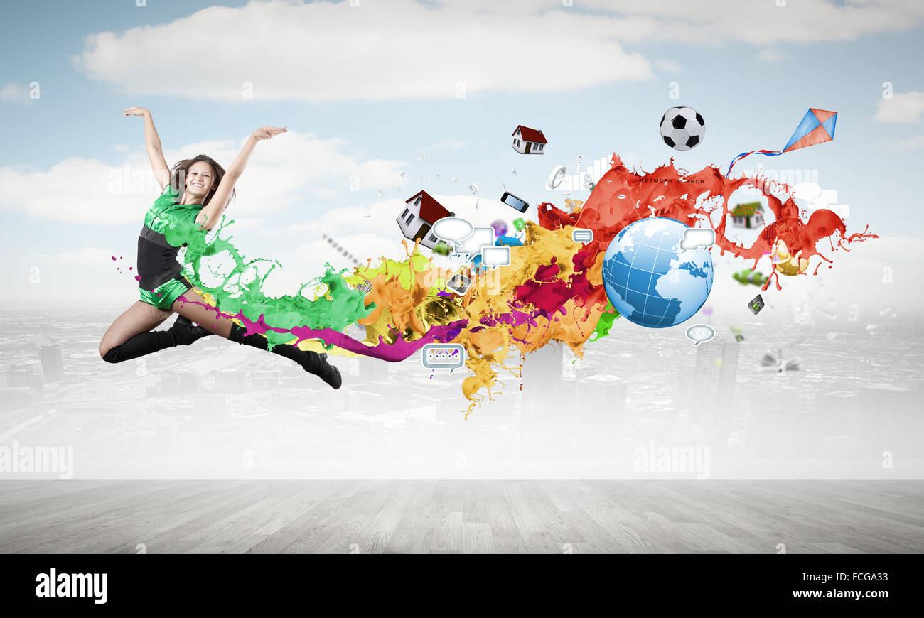 Young woman dancer in green suit jumping high Stock Photo - Alamy