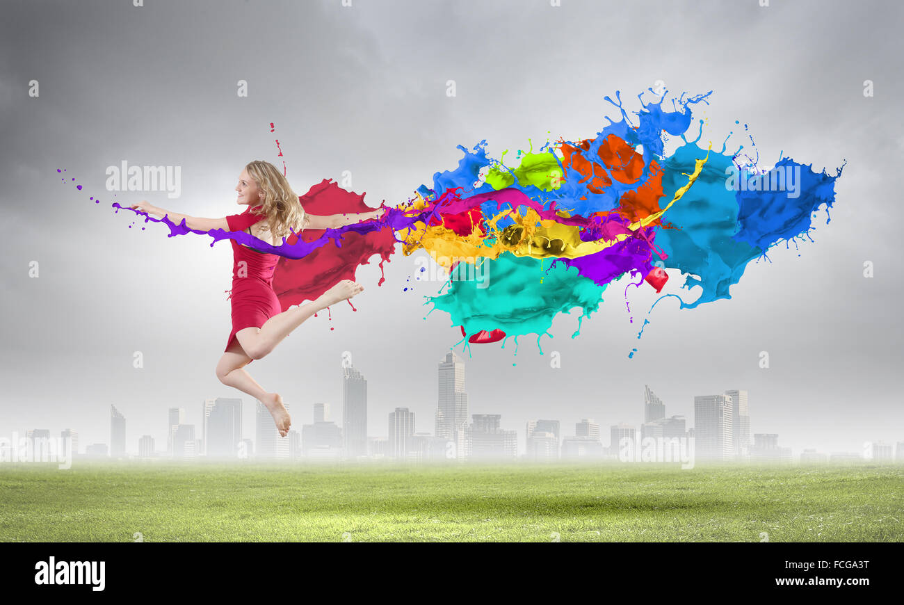 Young woman dancer in red dress jumping high Stock Photo - Alamy