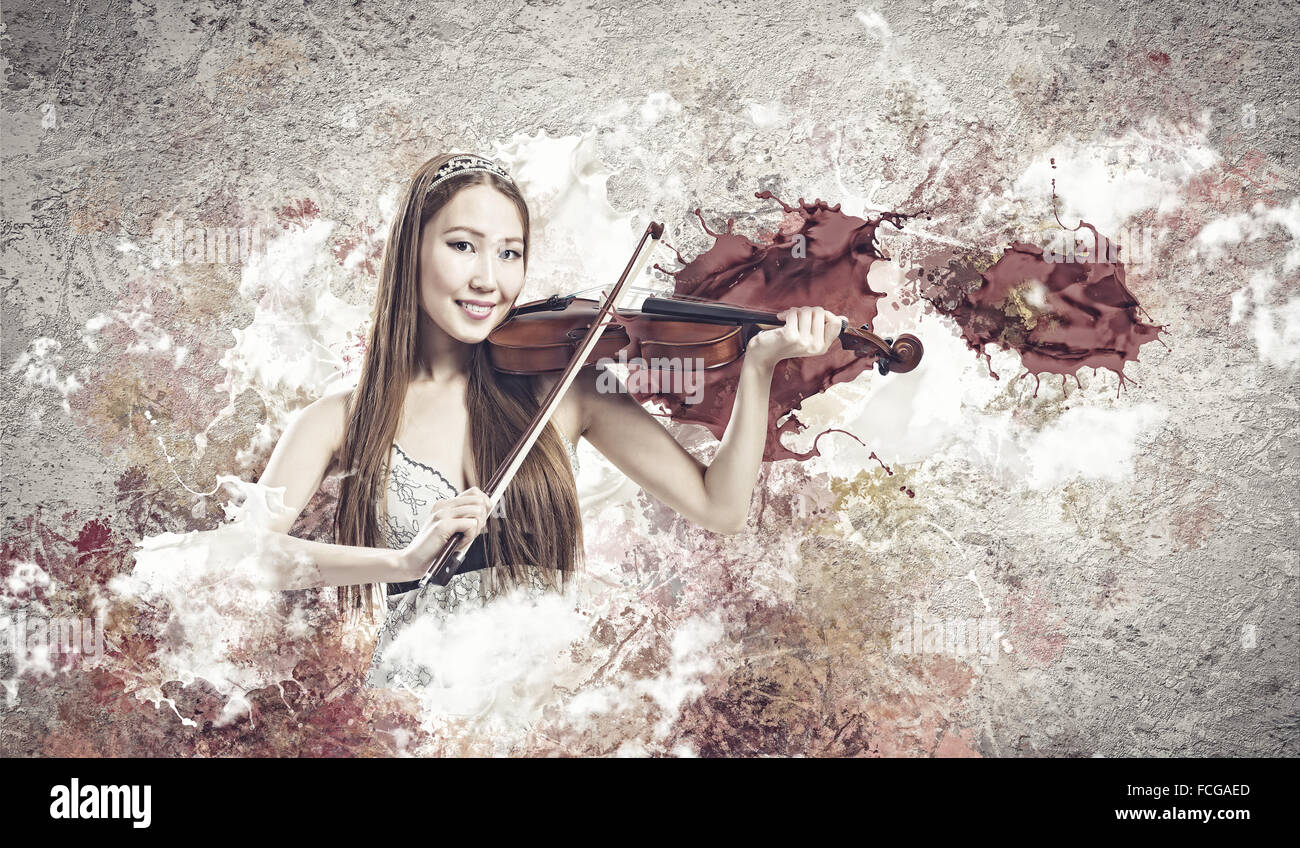 Young pretty asian woman playing violin. Young talent Stock Photo - Alamy
