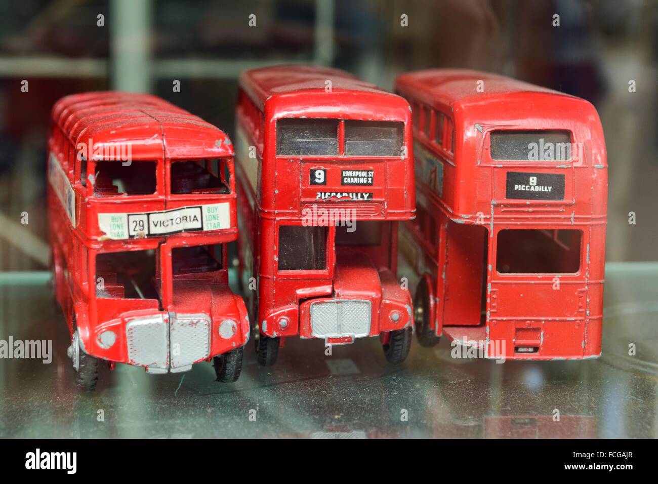 Three miniature model replica of a red London double-decker bus, front ...