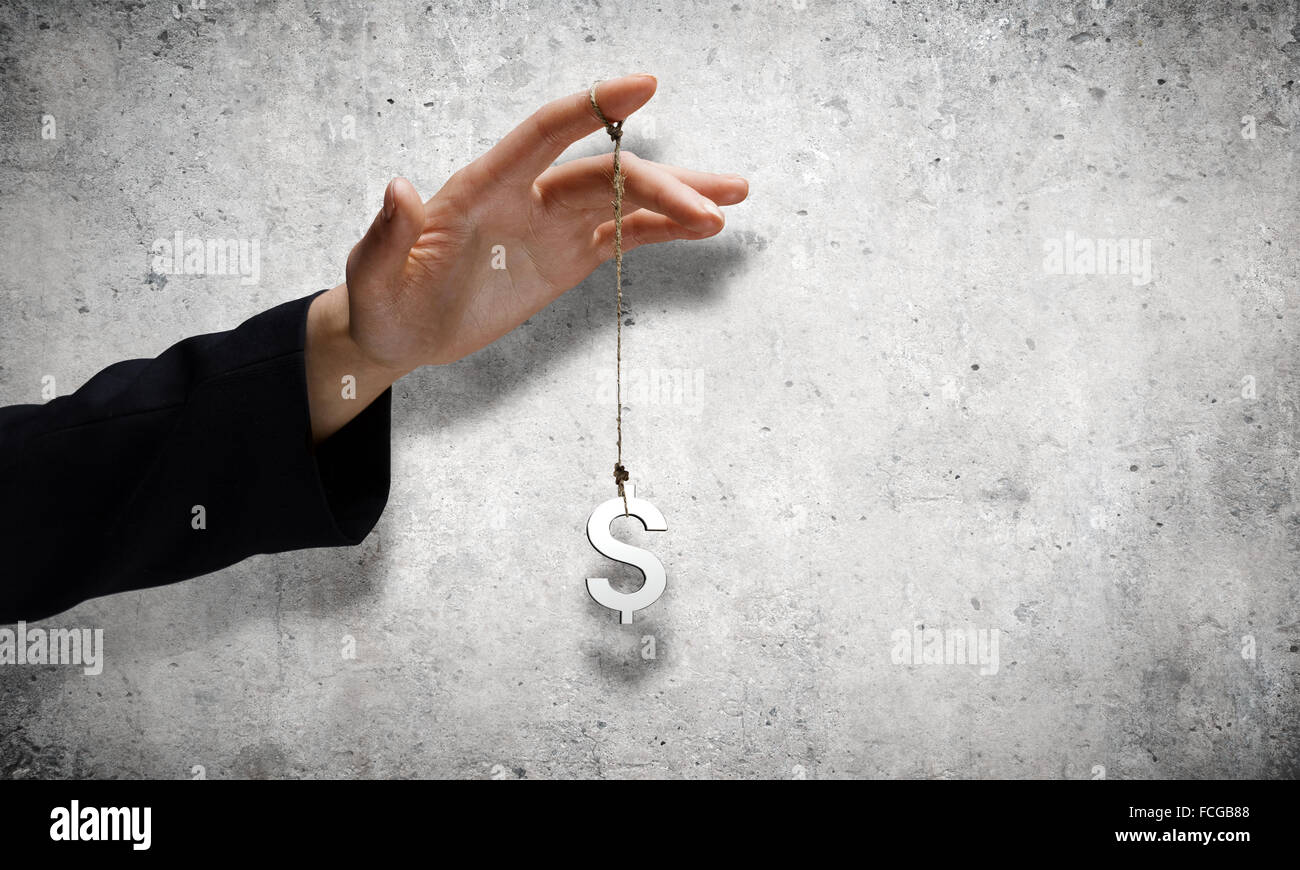 Close up of male hand holding dollar sign on rope Stock Photo - Alamy