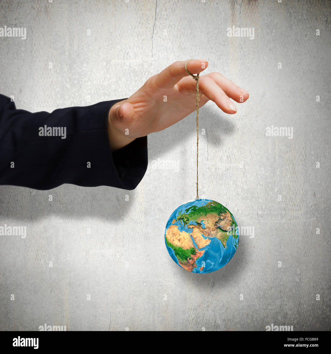 Close up of male hand holding Earth planet on rope. Elements of this ...