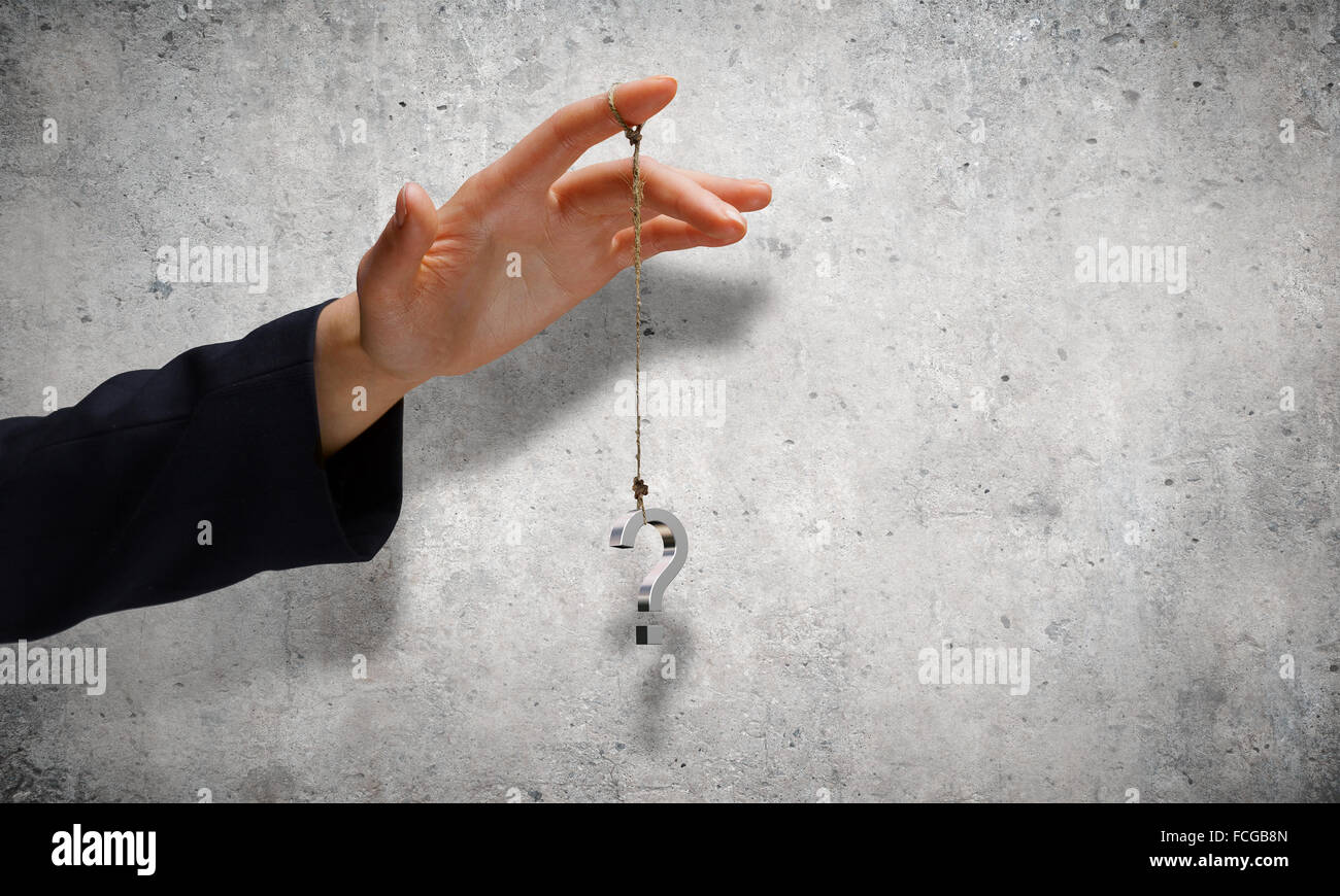 Close up of male hand holding question mark on rope Stock Photo - Alamy