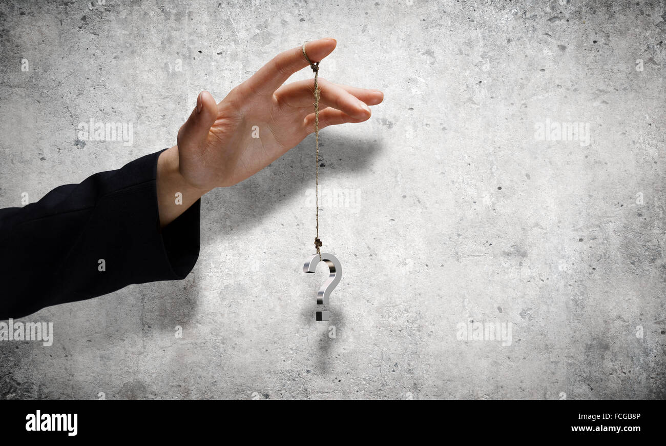Close up of male hand holding question mark on rope Stock Photo - Alamy